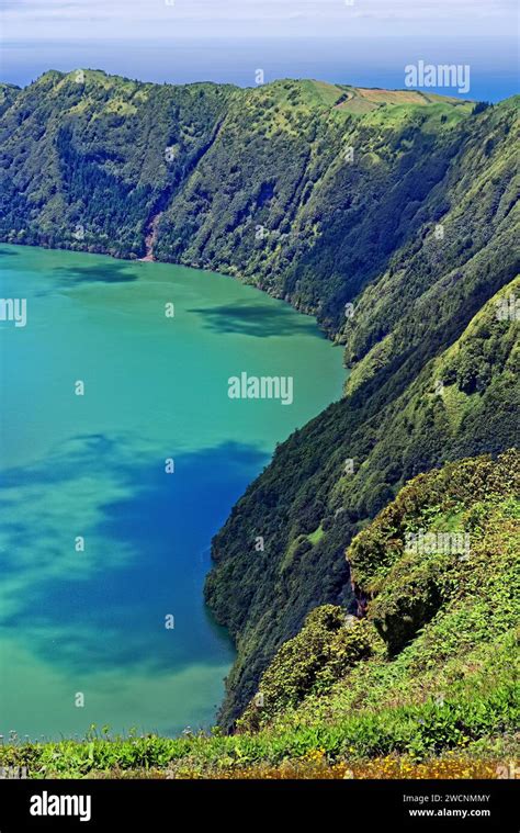 Bright Blue Crater Lake Lagoa Azul With Steep Green Crater Rim Lagoa