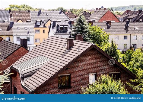 Red Brick Roof With Chimneys And Tv Antennas On A Clear Blue Sky Stock