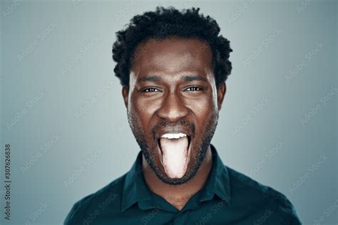 Handsome Young African Man Looking At Camera And Sticking Out Tongue