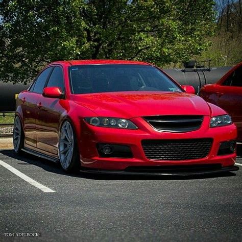 Red Mazda Car Parked In A Lot
