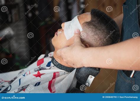 Man Receiving Massage On His Head After Finished Haircut By