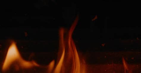 A Fire Is Burning In A Fireplace With A Black Background Free Stock
