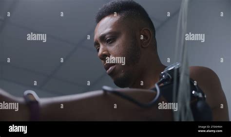 African American Man With Tonometer And Sensors Pedals Orbitrek In