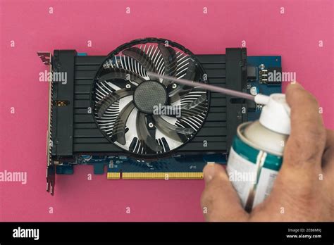 Selective Focus Of A Pc Graphics Card Being Cleaned With A Can Of Cold Compressed Air Computer