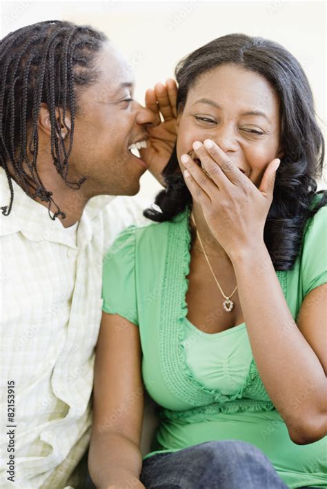 Man Whispering In Womans Ear