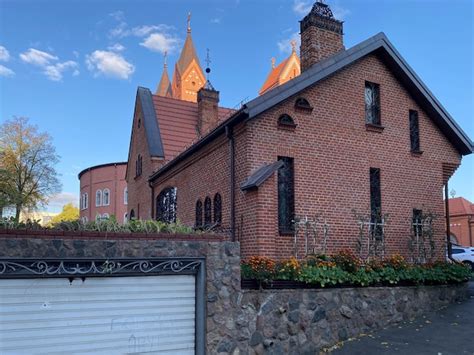 Premium Photo A Beautiful Maple Tree And Red Brick Building