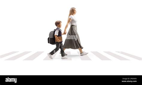 Mother Taking Son To School And Crossing Street At A Pedestrian Zebra