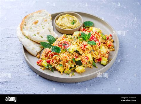 Traditional Moroccan Vegetable Couscous With Pita Bread And Hummus