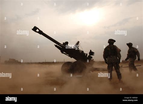 Us Army Soldiers Train On Firing Points With An M119 Howitzer Outside