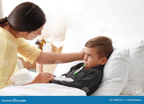 Mother Measuring Temperature Of Her Sick Son Stock Image Image Of