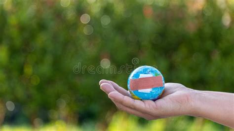 The Small Globe Earth Is On Hand Grass Leaf The Globe Has Maps On
