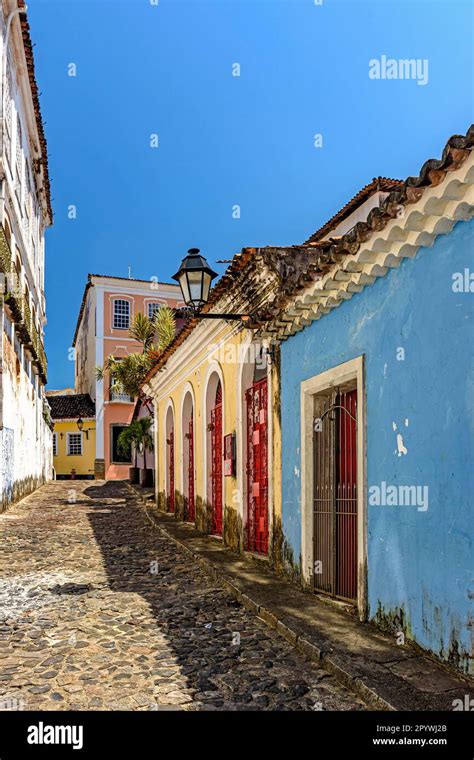 Colorful Facades Of Colonial Style Houses On A Cobblestone Street In
