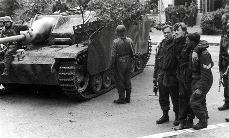 Captured British 1st Airborne Paratroopers Walk Past A Stug Iii