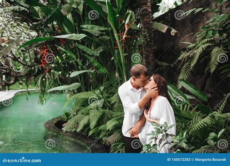 Happy Couple Kissing While Relaxing In Outdoor Spa Swimming Pool Stock