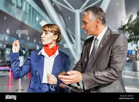 Passenger Service Agent Assisting Passenger To His Gate In Airport