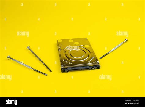 Computer Hard Disk Drive Isolated On Yellow With A Screwdriver Isolated Stock Photo Alamy