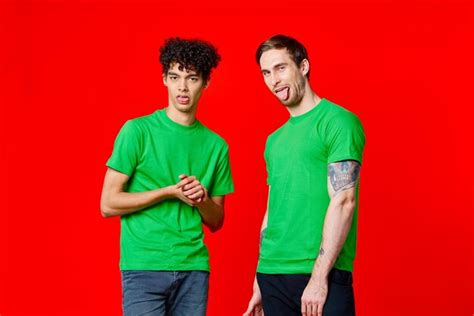 Premium Photo Two Friends In Green Tshirts Are Standing Next To Tin