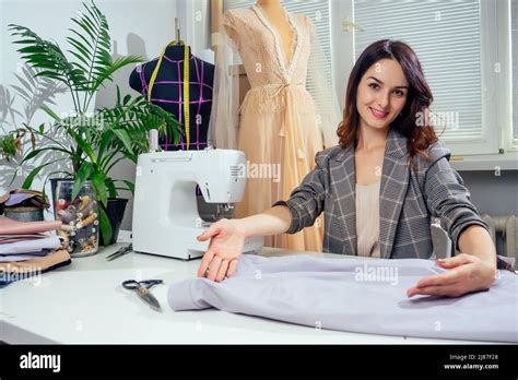 Portrait Of A Seamstress In In A Checkered Jacket Working In Her Sewing
