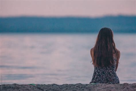 Girl Sitting Alone On Beach