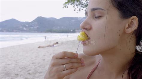 Closeup Brunette Girl Eats Pineapple Fruit On Sand Beach Bon Island