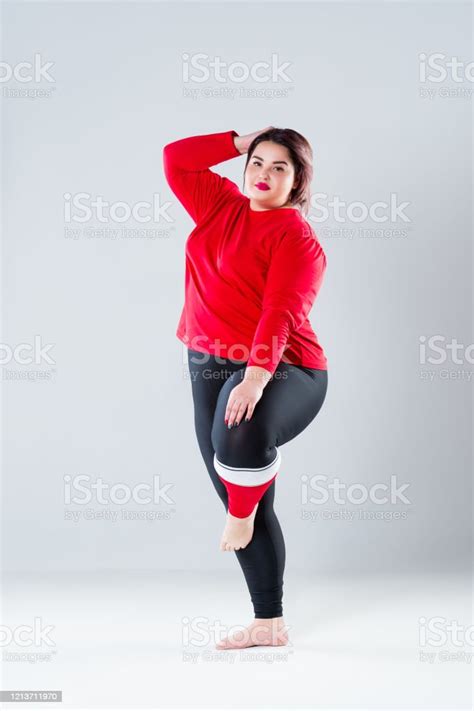 Plus Size Model In Sportswear Fat Woman Doing Workout On Gray