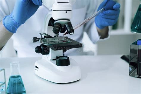 Chemist Scientist Holding Test Tube And Tablet Conducting Experiment In