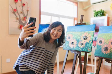 Young Woman Taking Selfie With Her Artwork By Stocksy Contributor