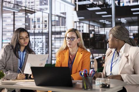 Female Executives Collaborating In Office Analyzing Data For Business