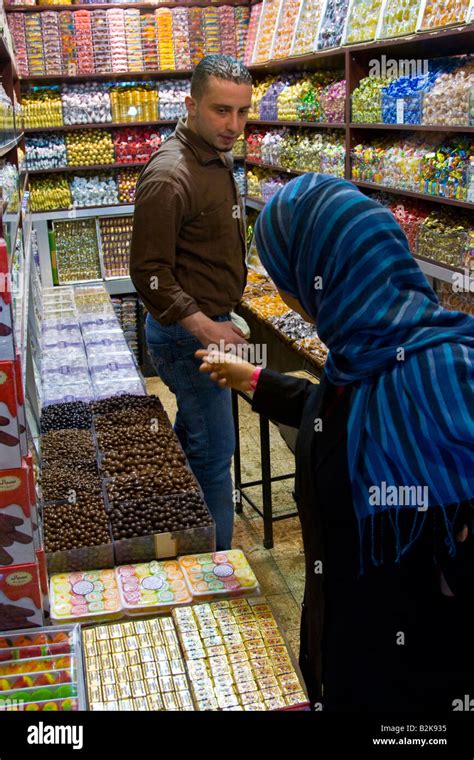 Woman Buying Candy At A Shop In The Souk In The Old City In Damascus