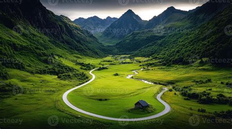 A Tranquil Green Valley With River And Cottages Nestled Between