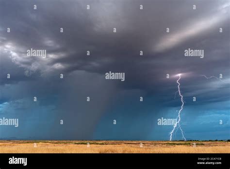 Arizona Monsoon Storm With A Lightning Bolt Striking In The Desert