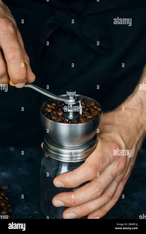 Grinding Coffee Beans By Hand At Nelson Roberto Blog