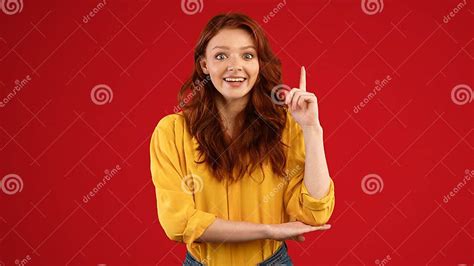 Excited Girl Having Great Idea Pointing Finger Up Green Background