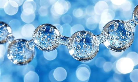 Clear Spherical Molecules Connected In A Chain Against A Blurred Blue