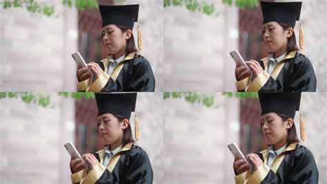 身穿毕业礼服的亚洲女大学生在校园里使用智能手机发短信视频素材下载编号9765036光厂vj师网