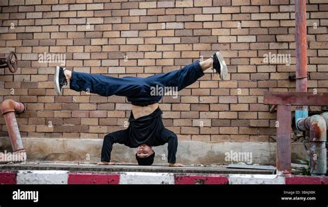 A Cool Energetic Asian Male B Boy Hiphop Breakdancer Is Showcasing His