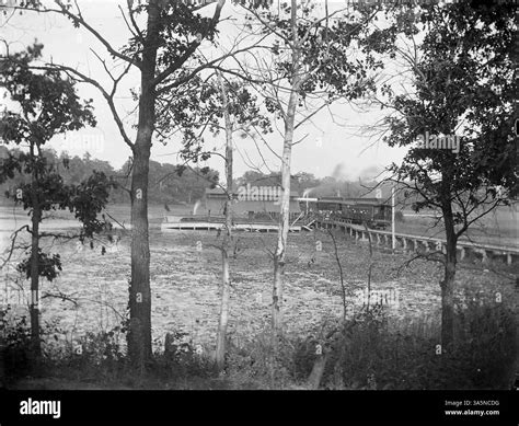 A Historic Scene Showing A Train Arriving At The Hotel St Louis Docks
