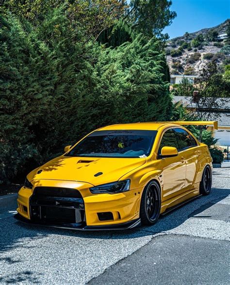 Yellow Mitsubishi Lancer Evolution Parked On The Side Of The Road