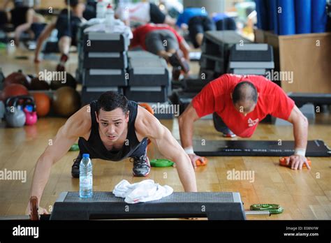 People Doing Push Ups During Body Pump Fitness Class At The Gym Stock