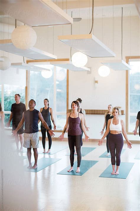 Yoga Class Doing Tree Pose By Stocksy Contributor Rob And Julia