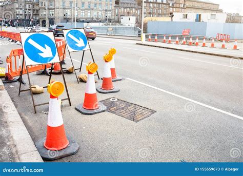 Signs And Traffic Cones At The Beginning Of A Construction Site Along A