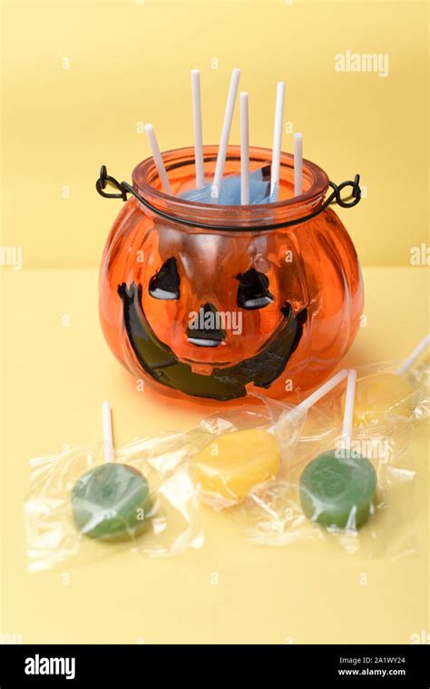 Trick Or Treat Pumpkin Full Of Halloween Sweets And Candy On Yellow