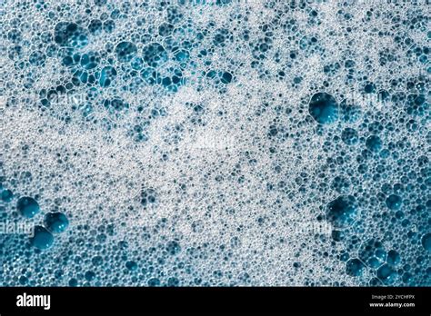 Background And Pattern White Soap Foam With Bubbles Texture On Blue Tile Background Detergent