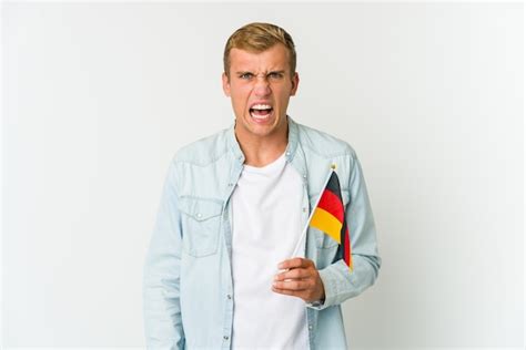 Premium Photo Young Man Holding A German Flag Screaming Very Angry