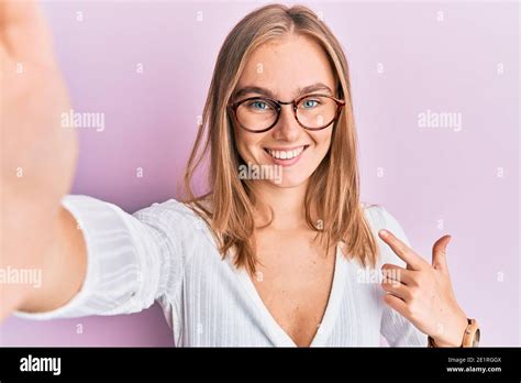 Beautiful Blonde Woman Taking A Selfie Photo Wearing Glasses Smiling
