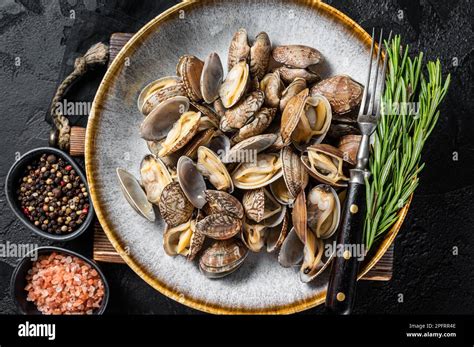 Steamed Cooked Shells Clams Vongole In A Plate With Herbs Black Background Top View Stock