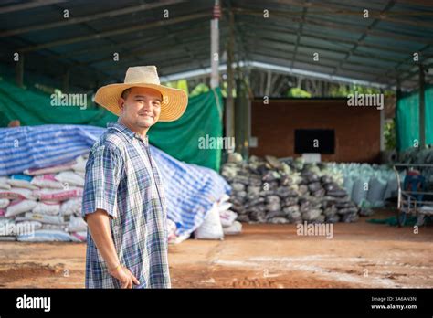 Asian Man Farmer Agriculturist Happy At A Fertilizer Composting Plant