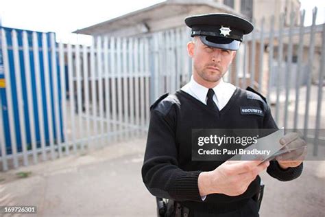 Security Guard Checking Identification Photos And Premium High Res