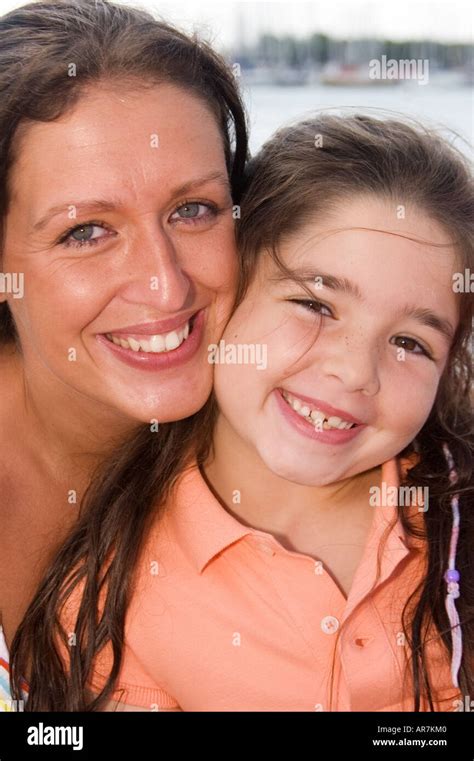Head And Shoulders Portrait Of Mother And Daughter Smiling And Happy