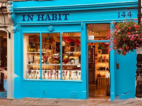 Bright Blue Storefront With In Habit Sign Photo Free Flowers Image